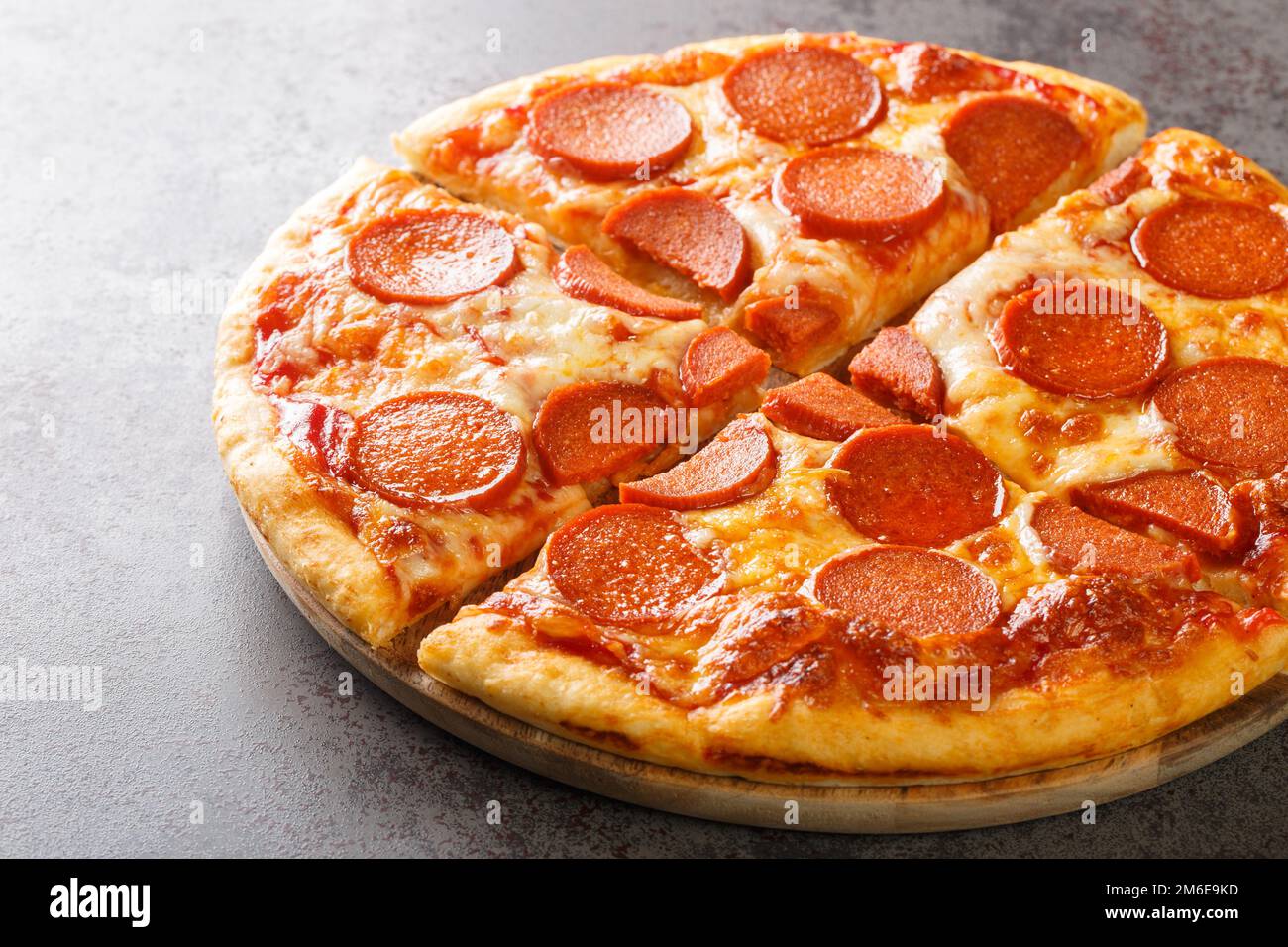 Classic pepperoni pizza with sausages, melted cheese and tomato sauce ...