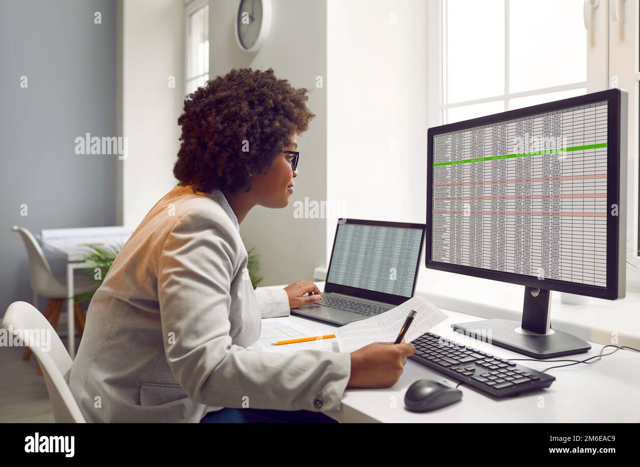 African american business woman accountant working on a laptop with ...