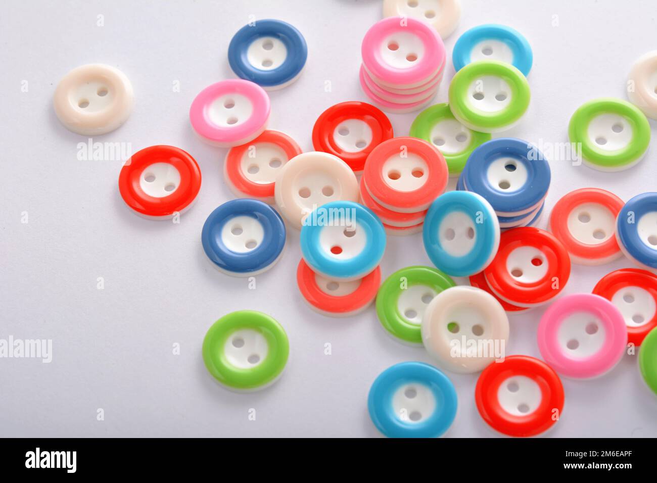 Pile of colorful buttons on white background Stock Photo - Alamy