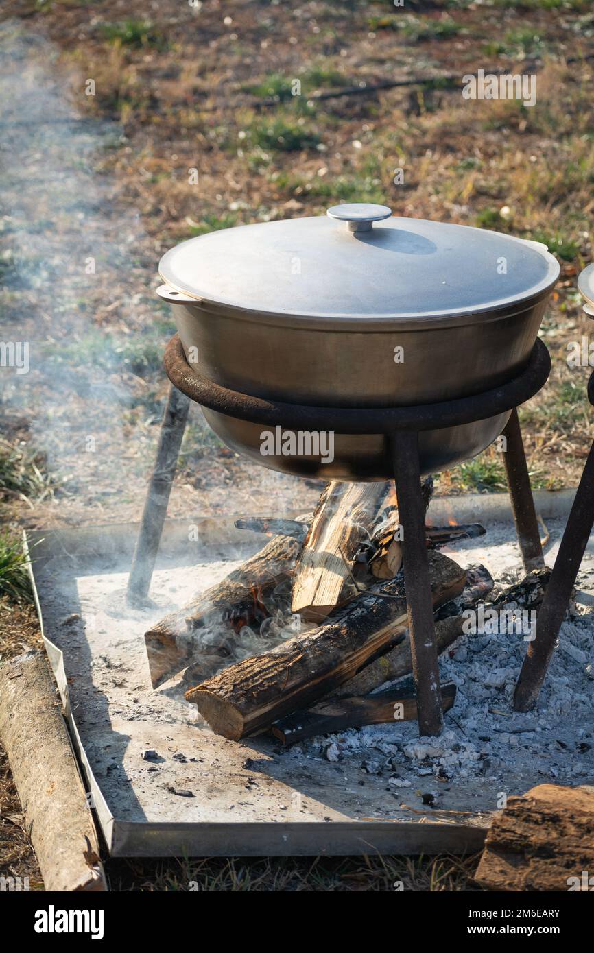 Kitchen outdoors, cooking at the stake, metal cauldron on the fire ...