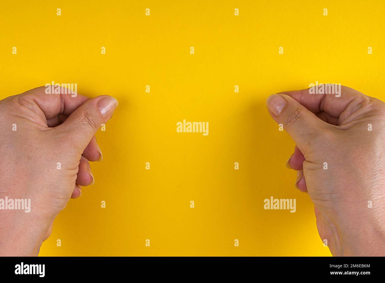 Hands with clenched fingers in a pinch Stock Photo - Alamy