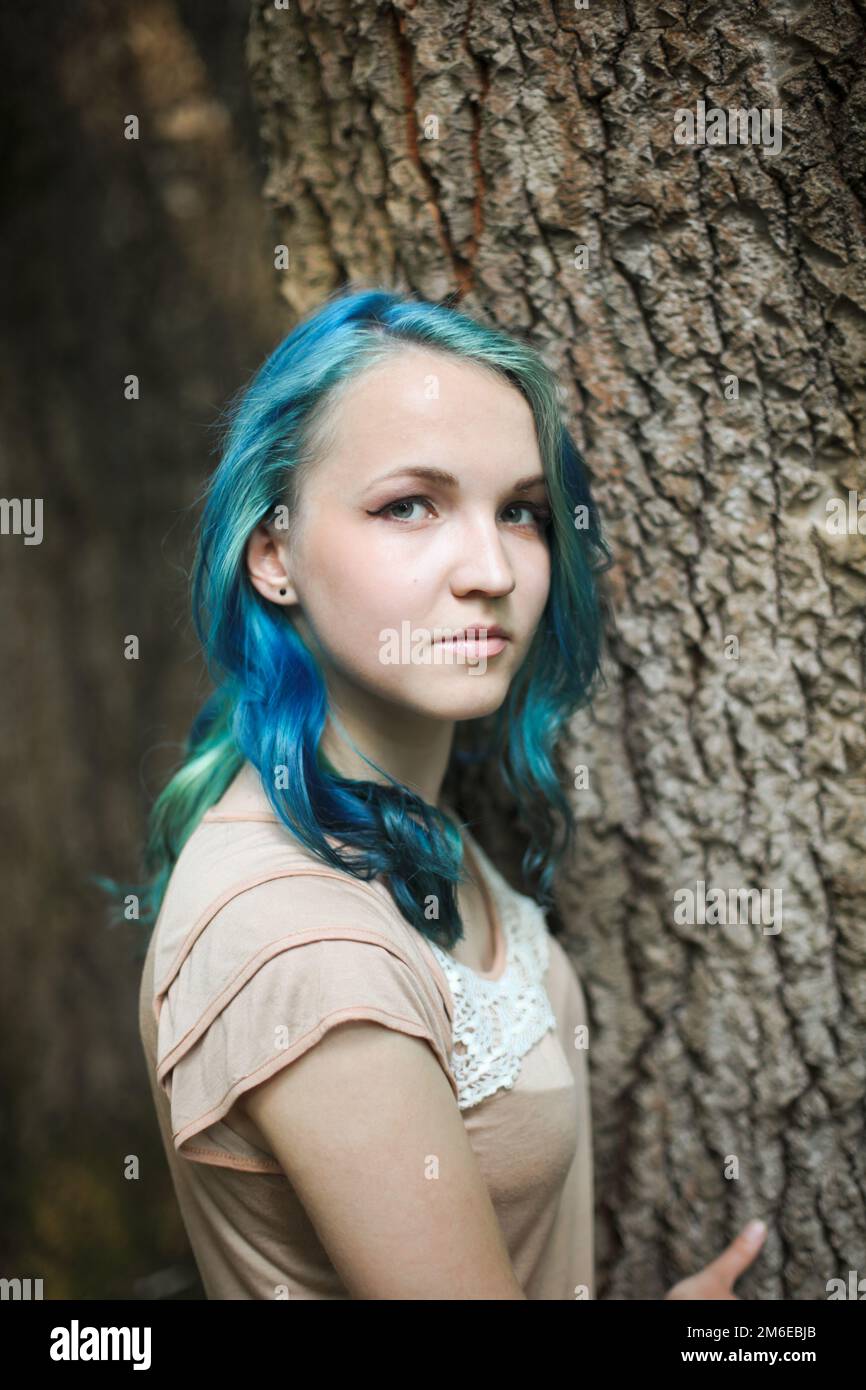 Young dreamy lgbt girl with colored blue hair Stock Photo - Alamy
