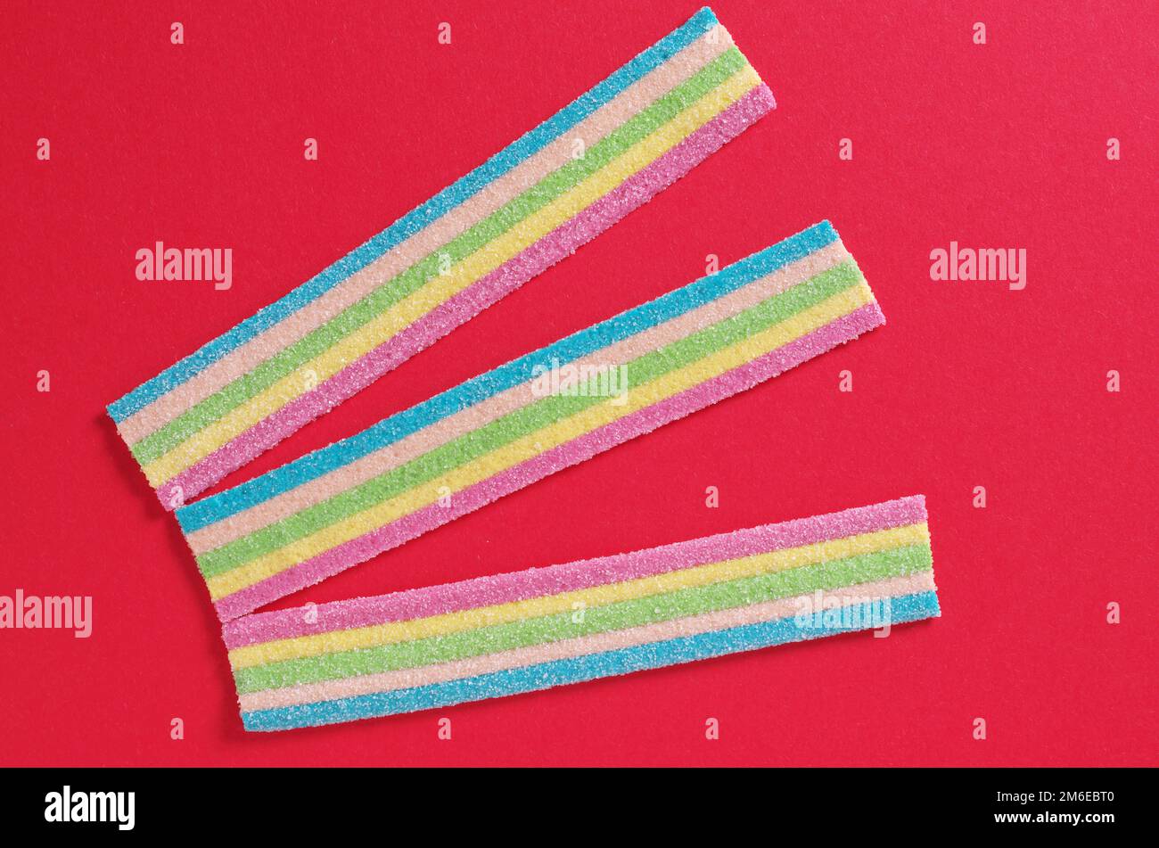 Multicolor gummy candy on red background close-up, top view Stock Photo ...