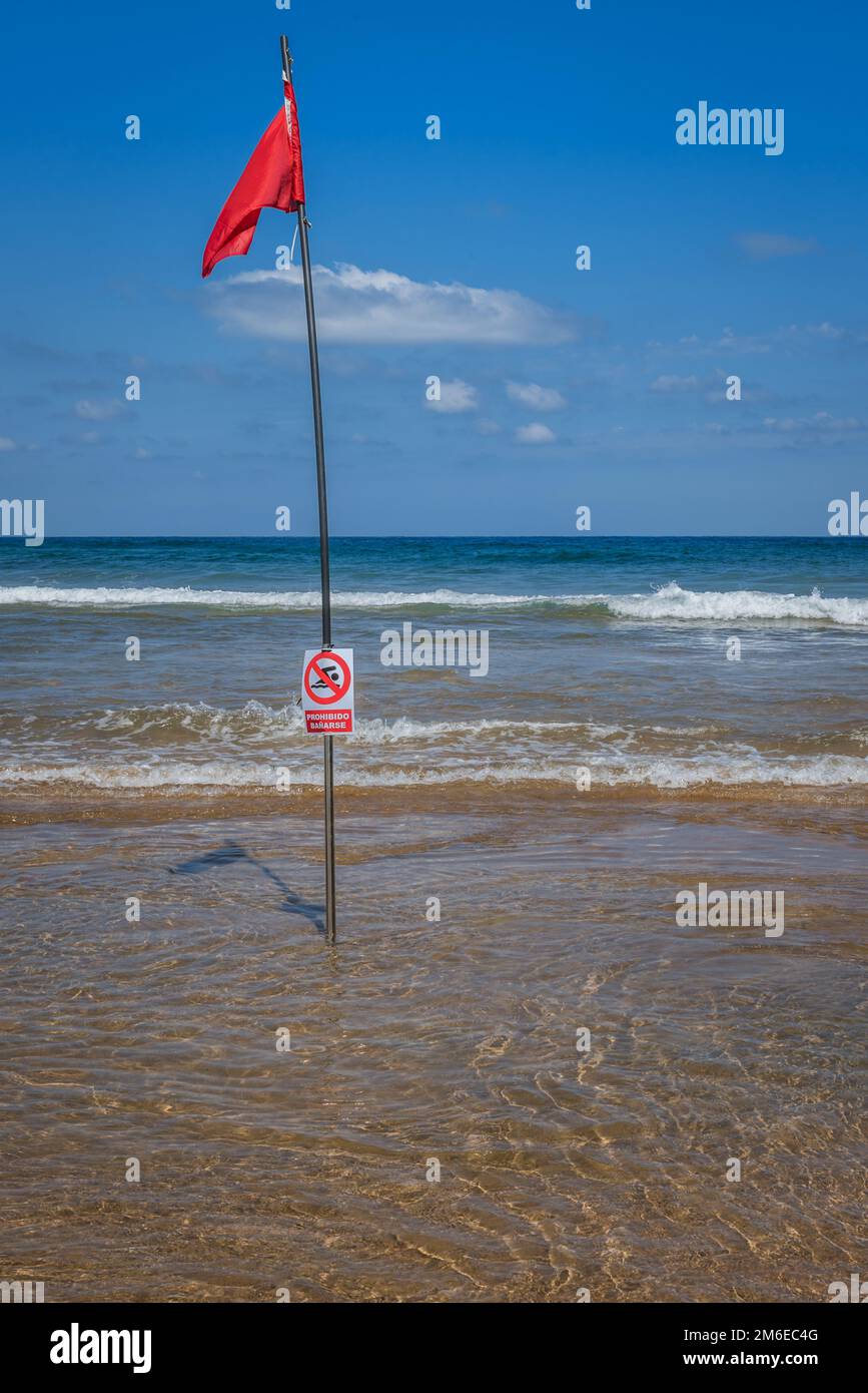 Red flag on the beach. Swimming and surfing ban Stock Photo - Alamy
