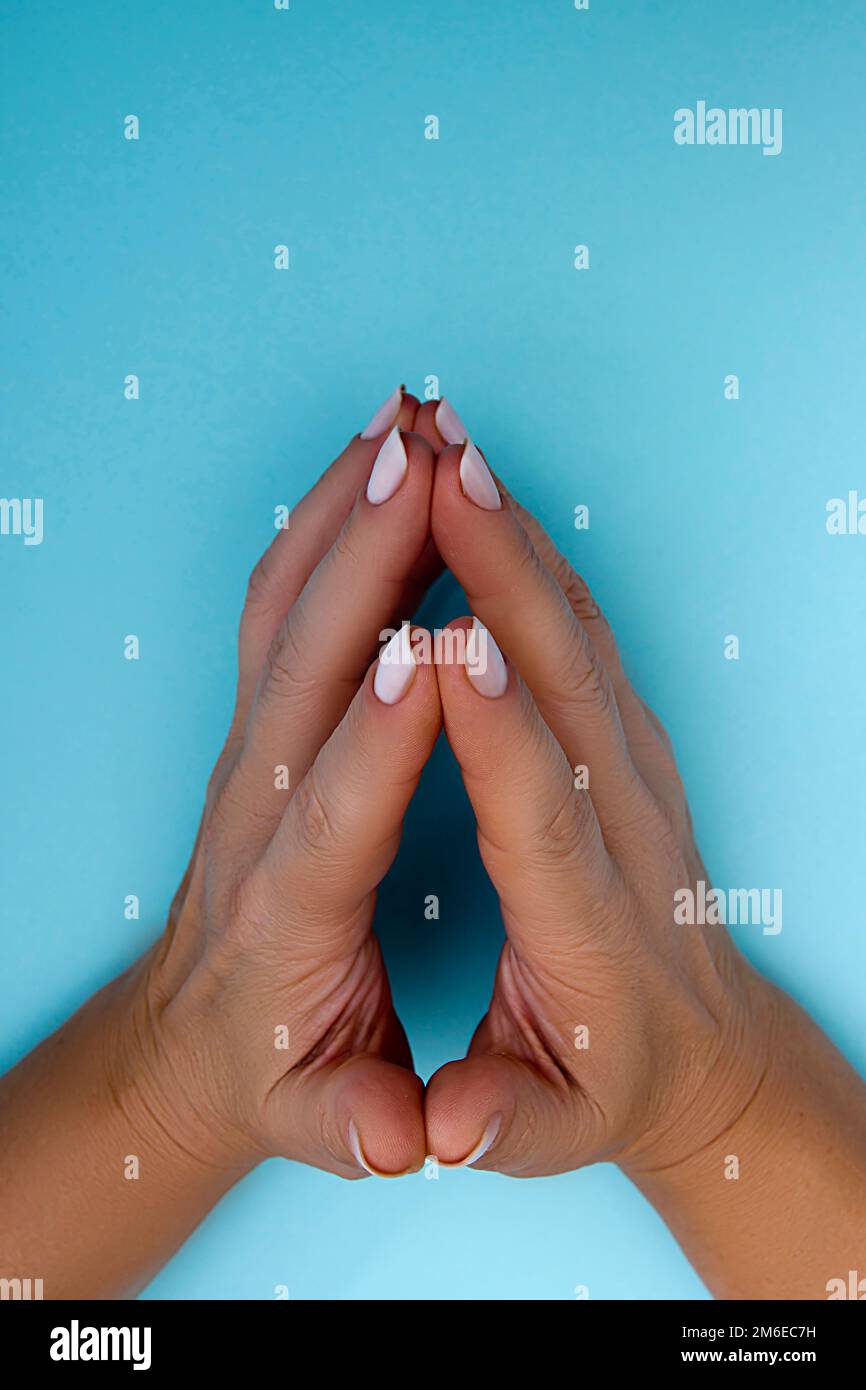 Folded female hands Stock Photo - Alamy