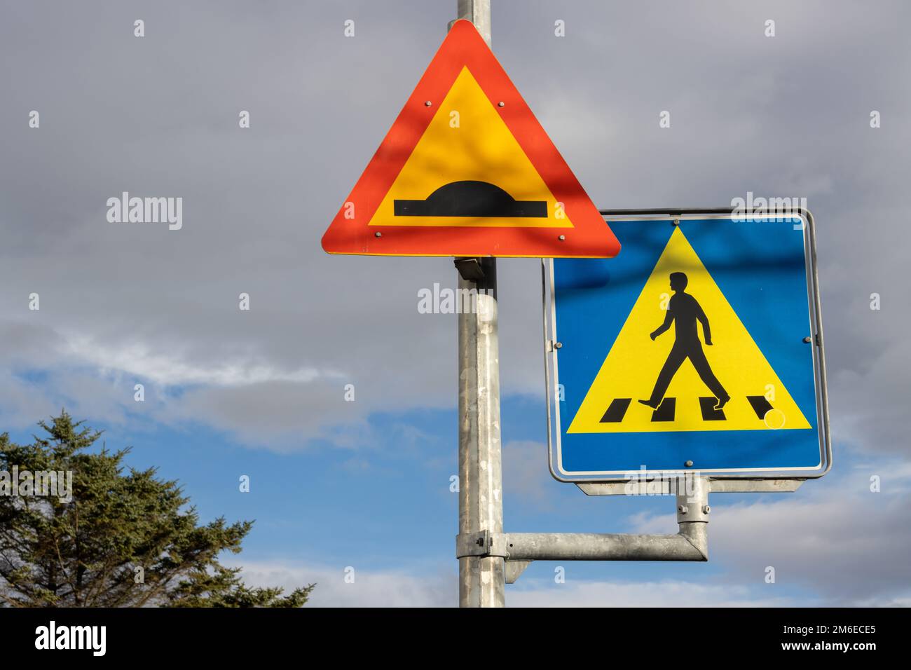Two traffic signs on a one pole, safety for the people passing the road ...