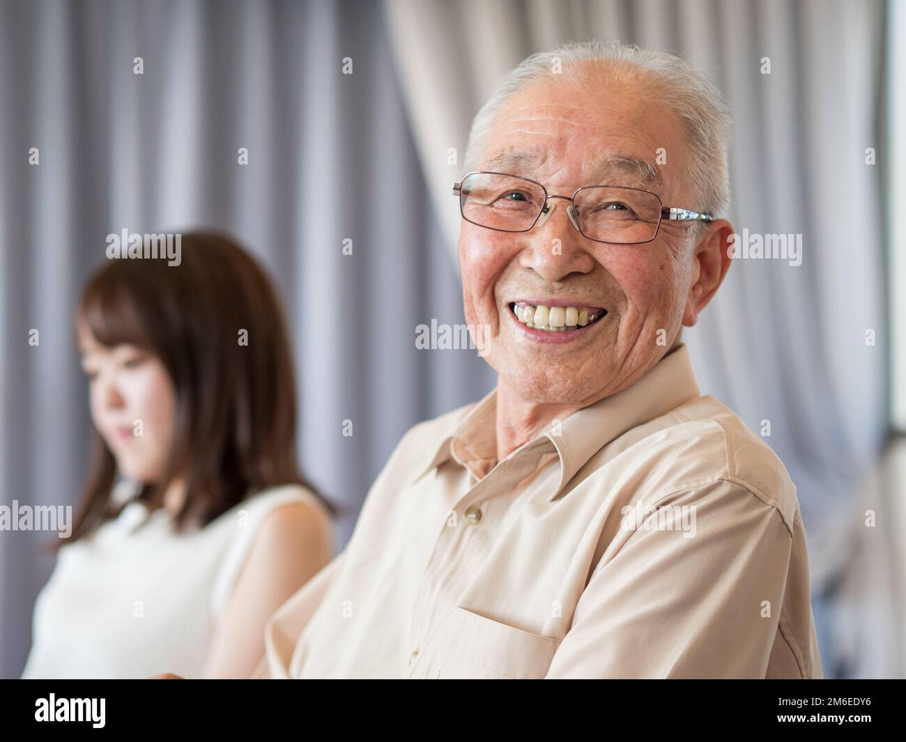 An old man talking animatedly at a family event Stock Photo - Alamy
