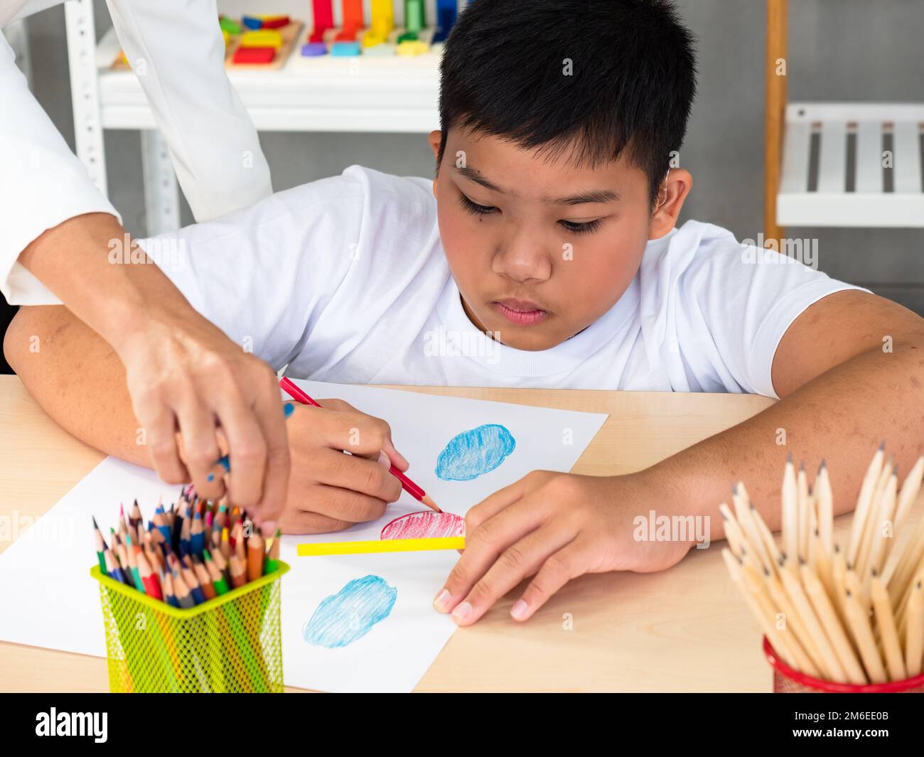 A cheerful group creative arts class for kids and their teacher in the ...