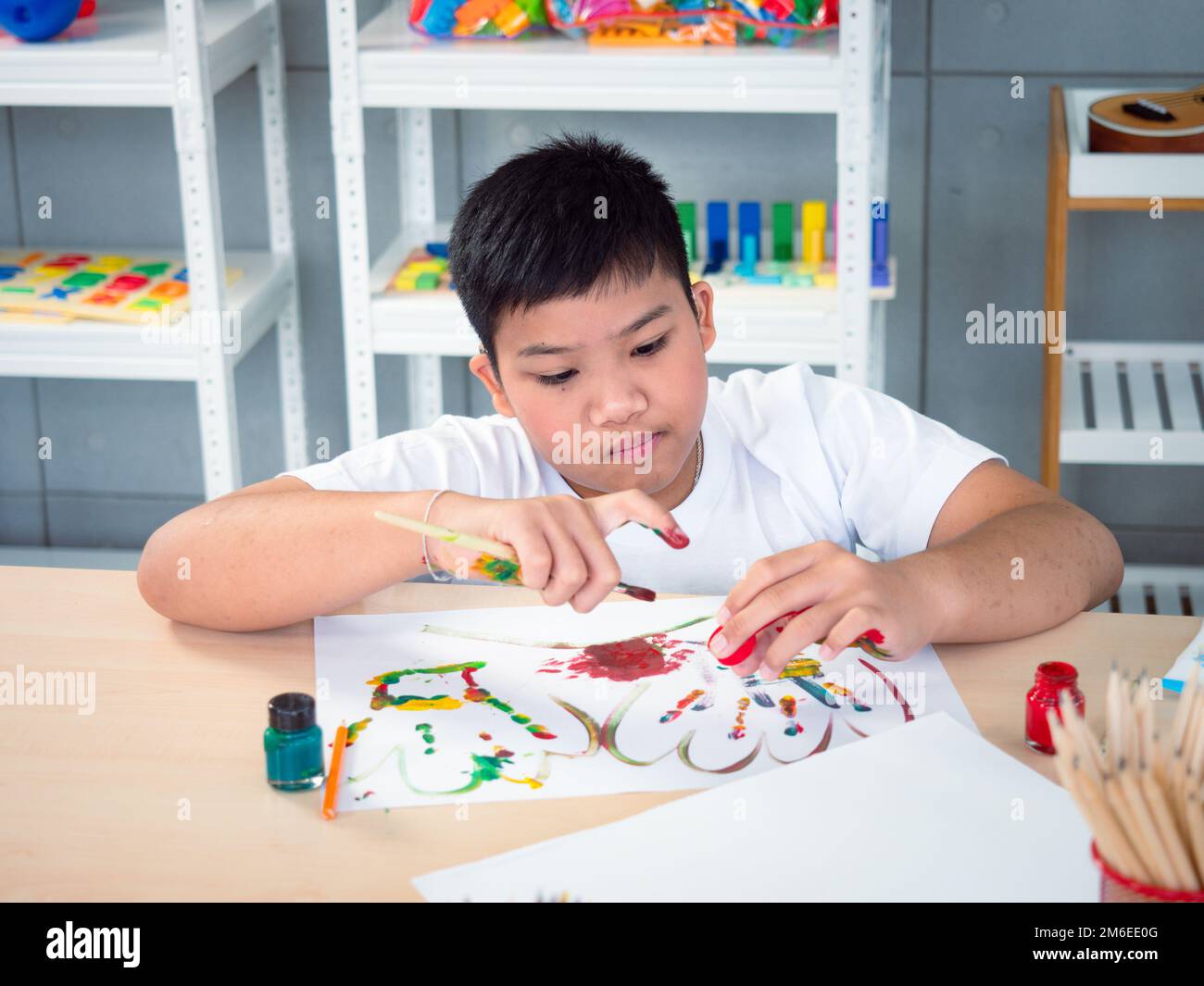 A cheerful group creative arts class for kids and their teacher in the ...