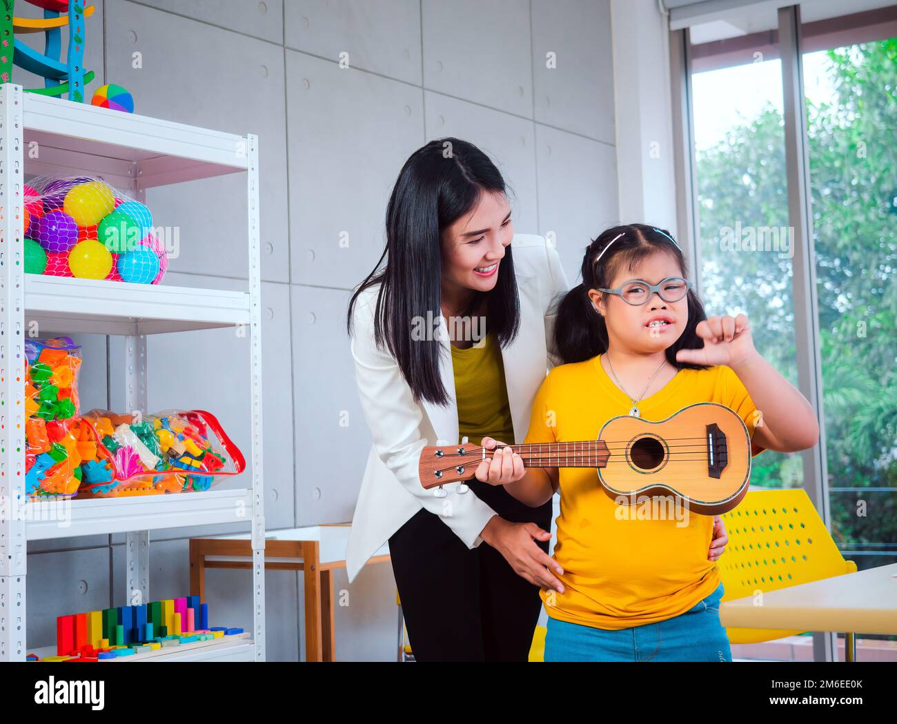 A cheerful group creative arts class for kids and their teacher in the ...