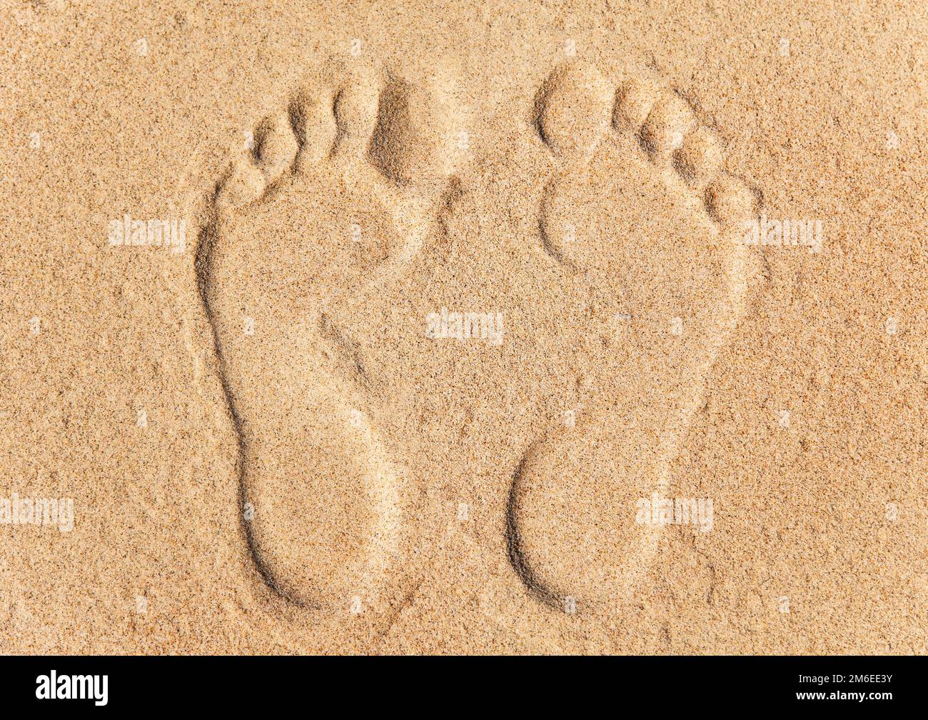 Two Footprints in sand at the Beach Stock Photo - Alamy