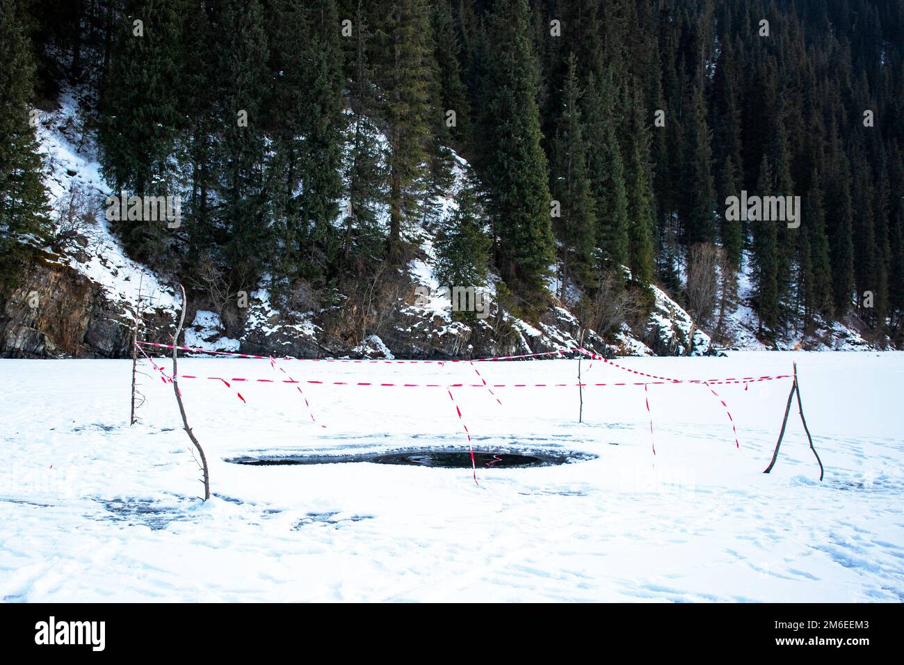 a polynya in a frozen lake fenced with a ribbon Stock Photo - Alamy
