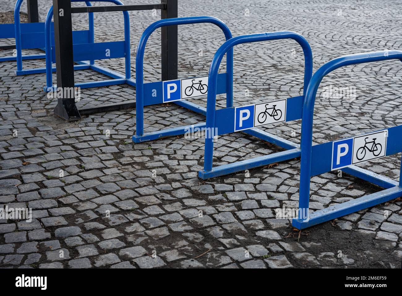 Blue bike parking sign with a bicycle background Stock Photo - Alamy