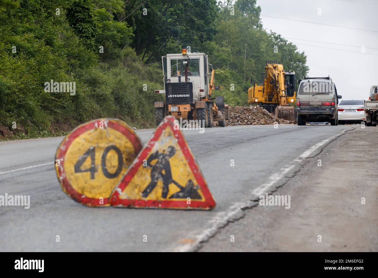 Summer, 2016 - Primorsky Krai, Russia - Repair of a bad road. Workers ...
