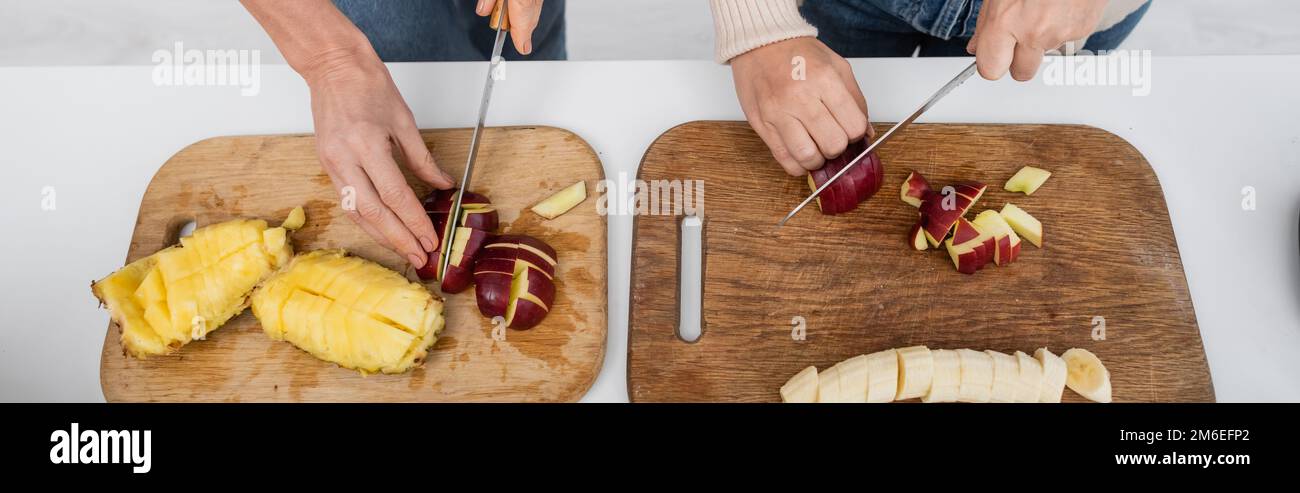 Top view of women cutting fresh fruits in kitchen, banner,stock image ...
