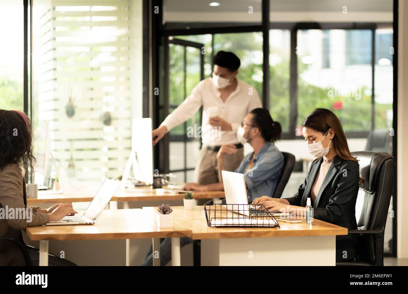 Social distance office with business team wear face mask as new normal ...
