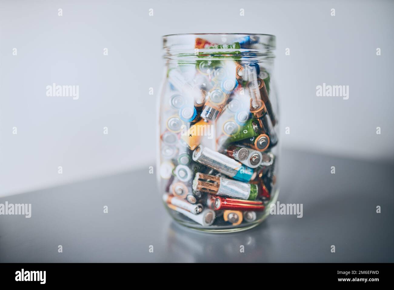 Jar filled with discharged used batteries. Waste disposal and recycling ...