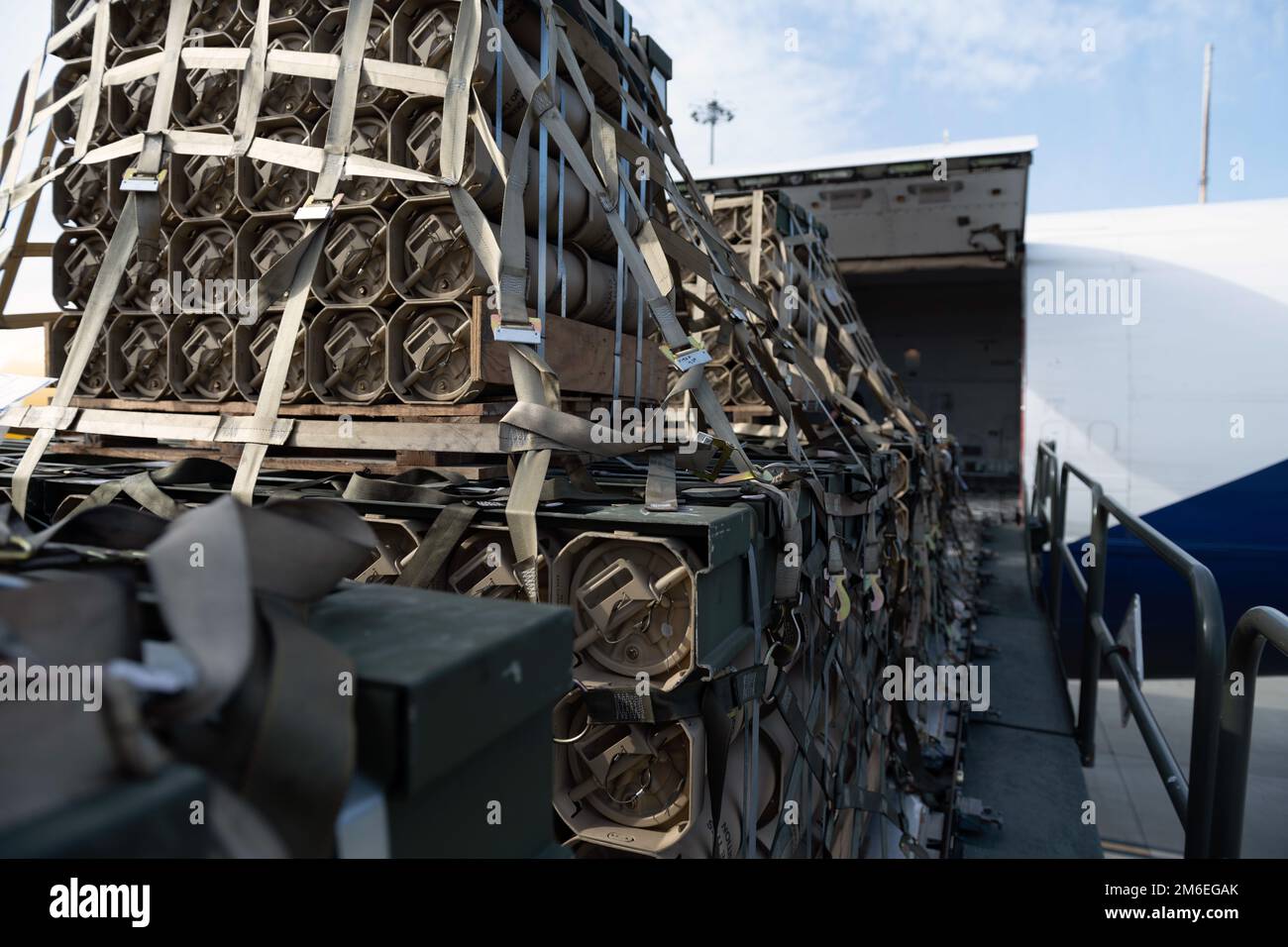 An aircraft cargo loader holding munitions aligns with the cargo ...