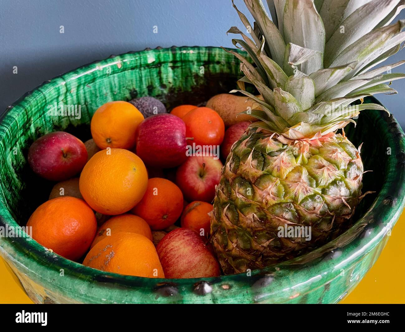 Green Moroccan fruit bowl from Tamegroute on yellow sideboard against ...