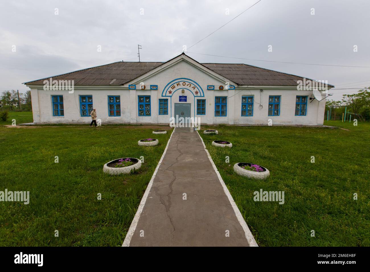 Whitewashed building of an old one-story school in the village Stock ...