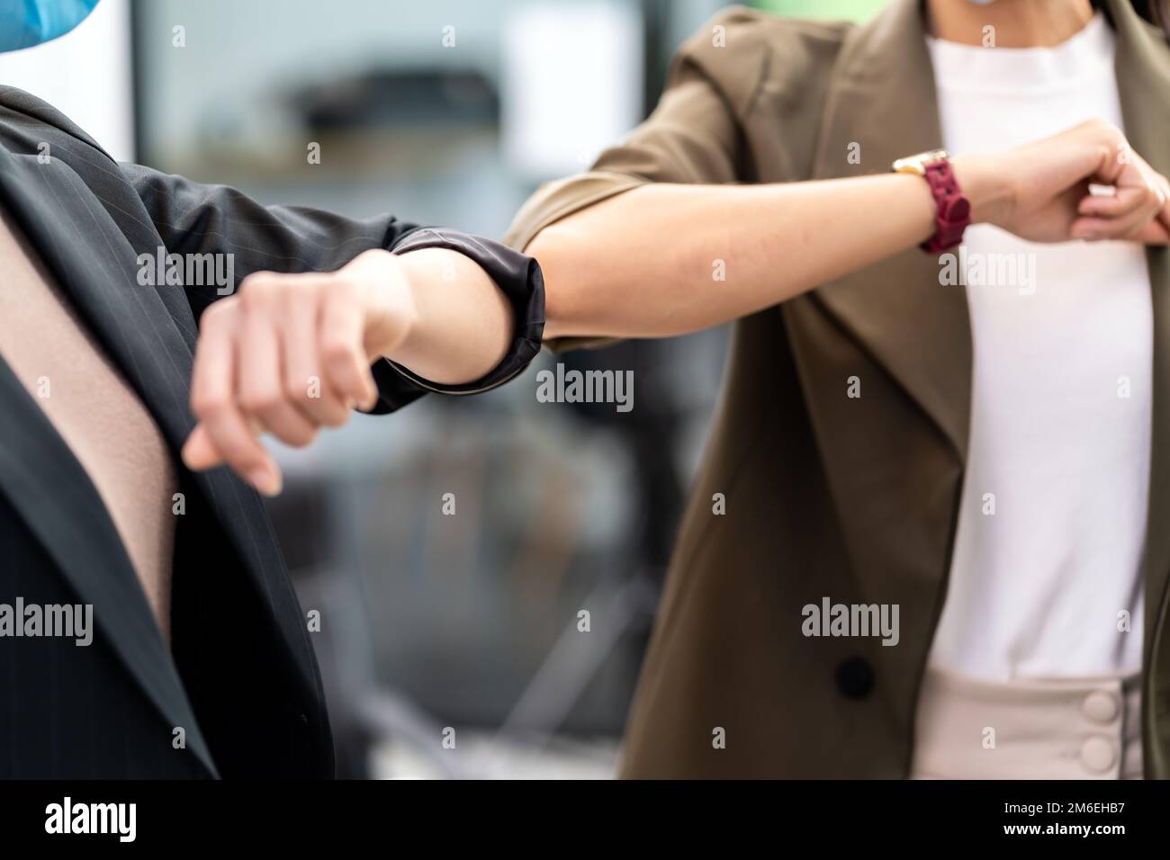 Businesswomen wear face mask elbow greeting in new normal office ...