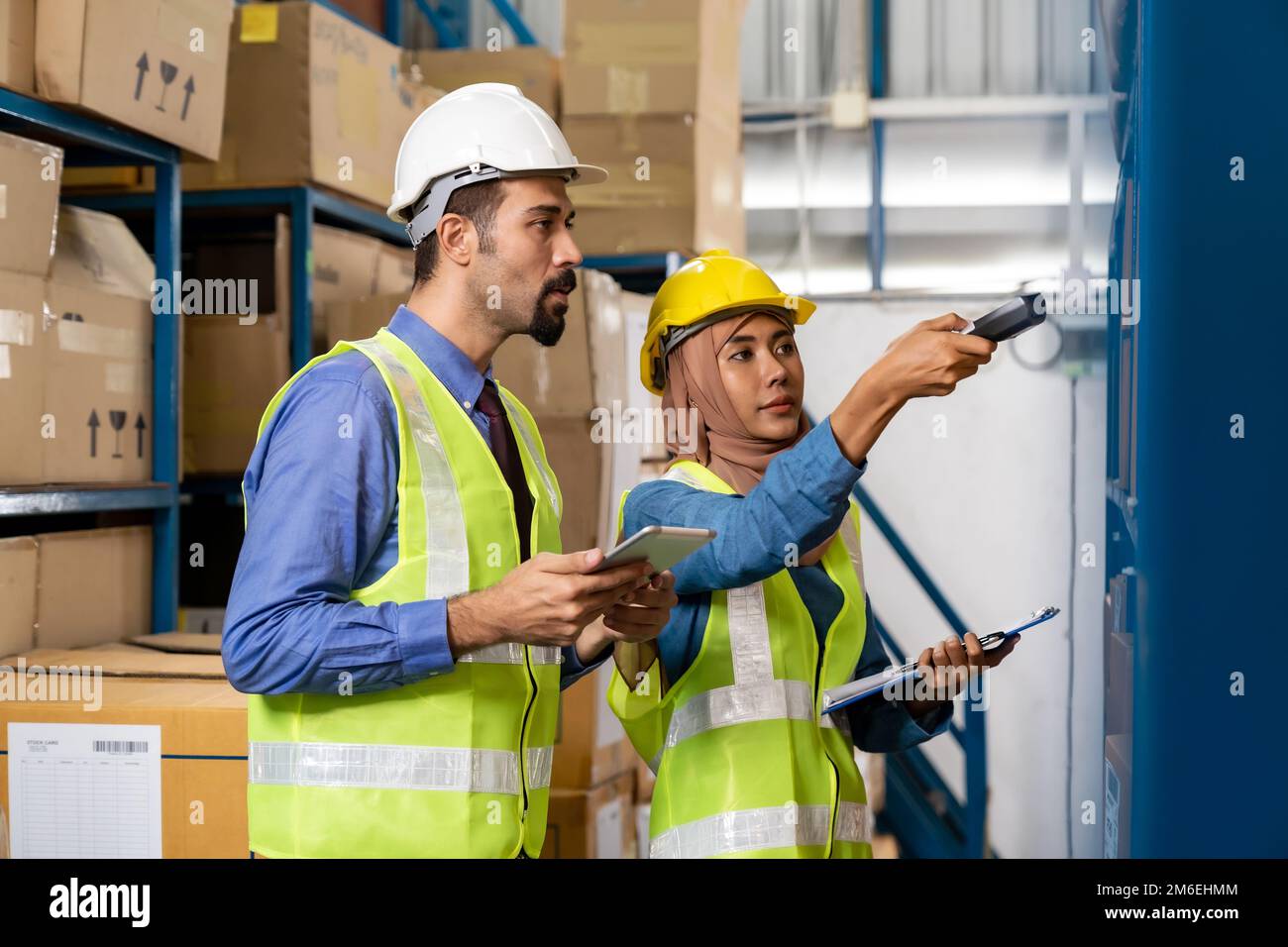 Warehouse manager working inventory with worker about logistic Stock ...