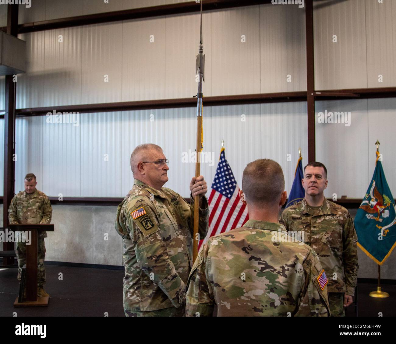 Command Sgt. Maj. Dean Reicks (left) holds a ceremonial halberd ...