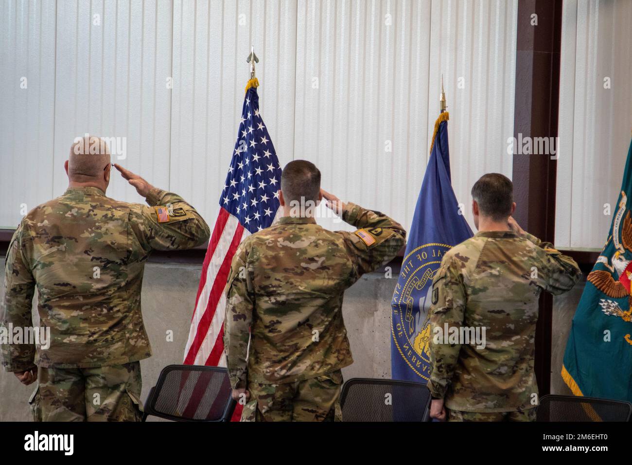 Command Sgt. Maj. Dean Reicks (left) salutes the U.S. flag during a ...