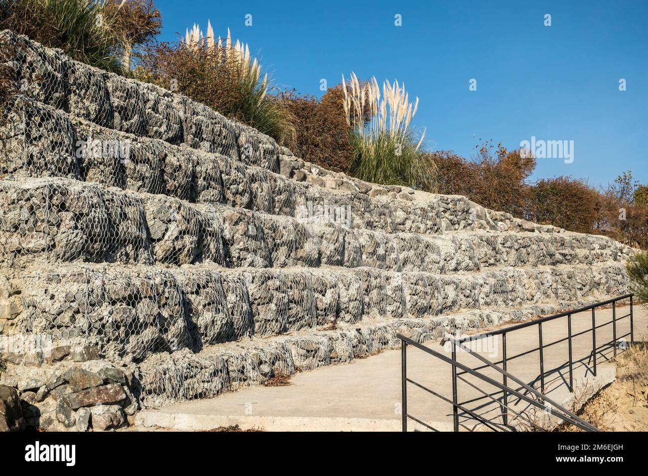 Gabion metal wire mesh support wall by seaside way Stock Photo - Alamy