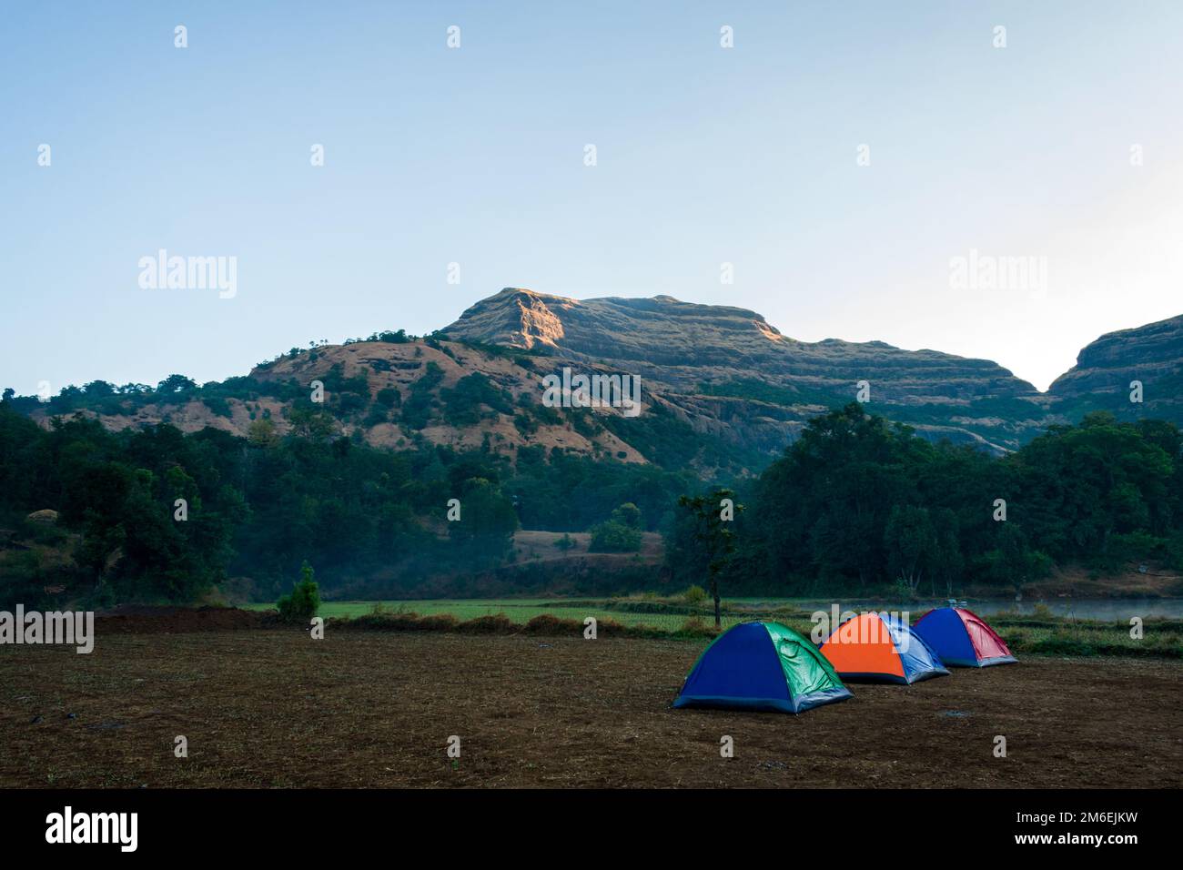Beautiful landscape of camp and tents with hills in the background at ...