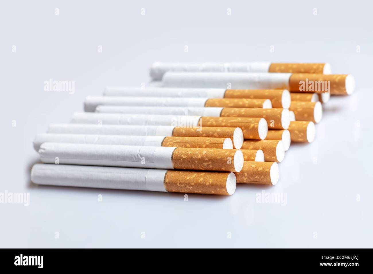Close up of a smoking cigarettes. cigarette filter tubes on white Stock ...