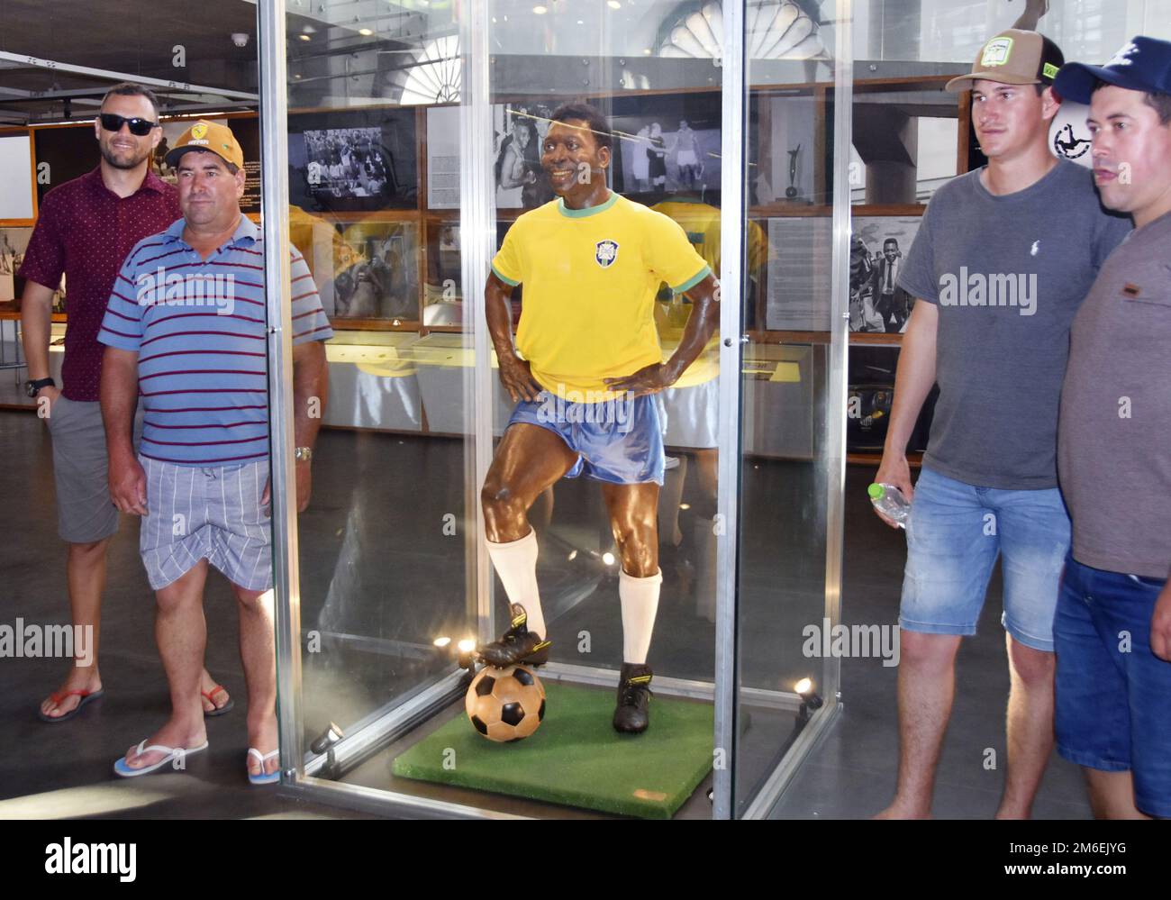 People pose for a photo with a figure of Pele at a museum dedicated to ...