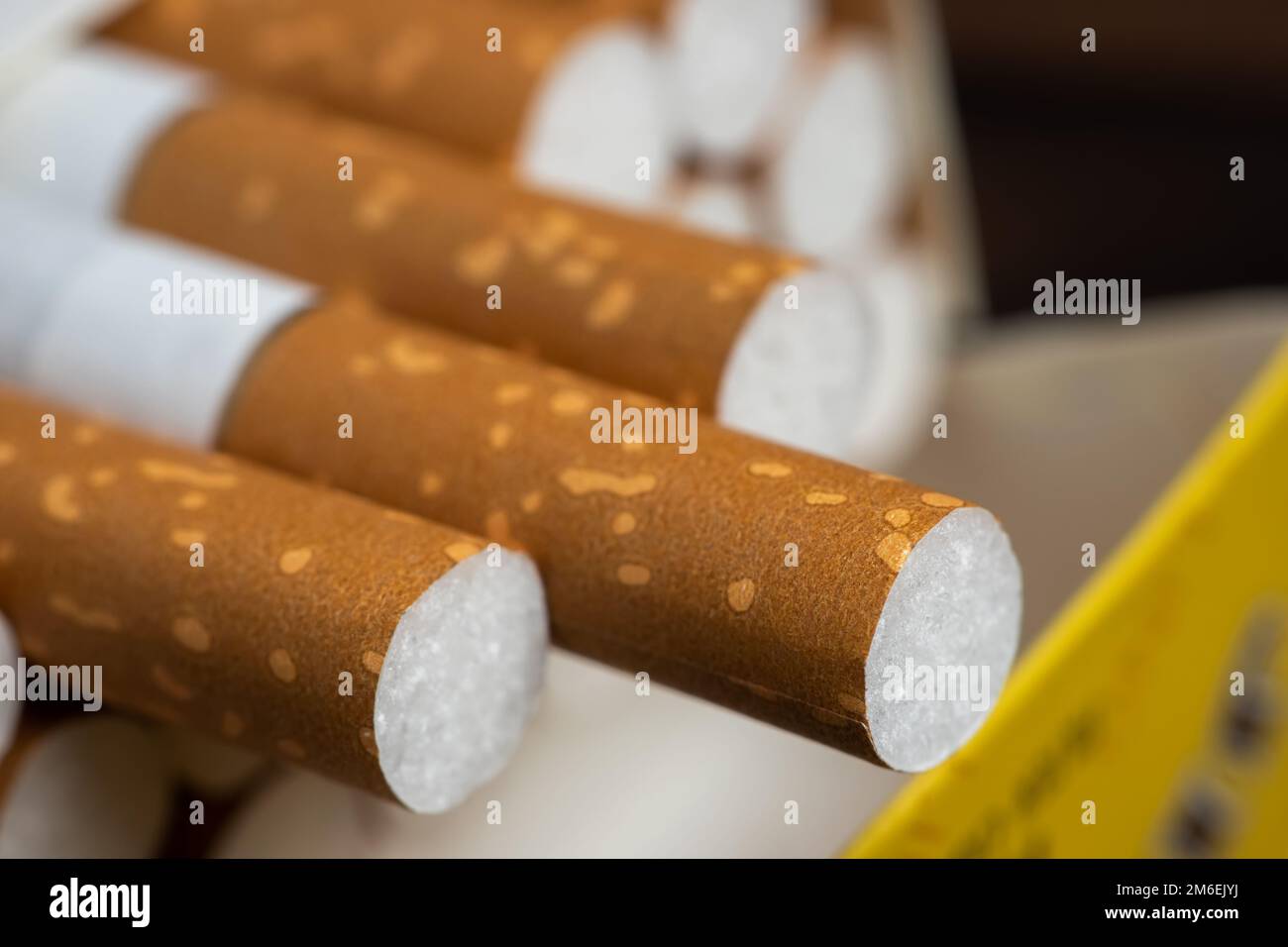 Cigarettes in a pack. Yellow filter. Harm to health. Bad habit. A pack ...