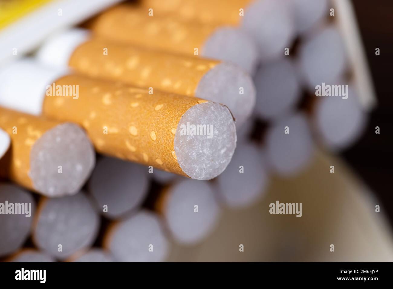 Cigarettes in a pack. Yellow filter. Harm to health. Bad habit. A pack ...