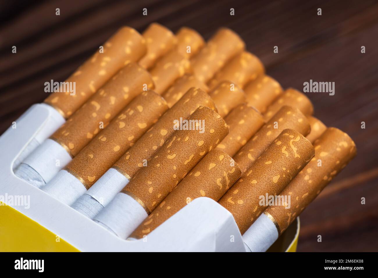 Cigarettes in a pack. Yellow filter. Harm to health. Bad habit. A pack ...