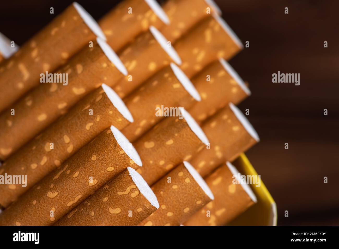 image of several commercially made cigarettes. pile cigarette on wooden ...