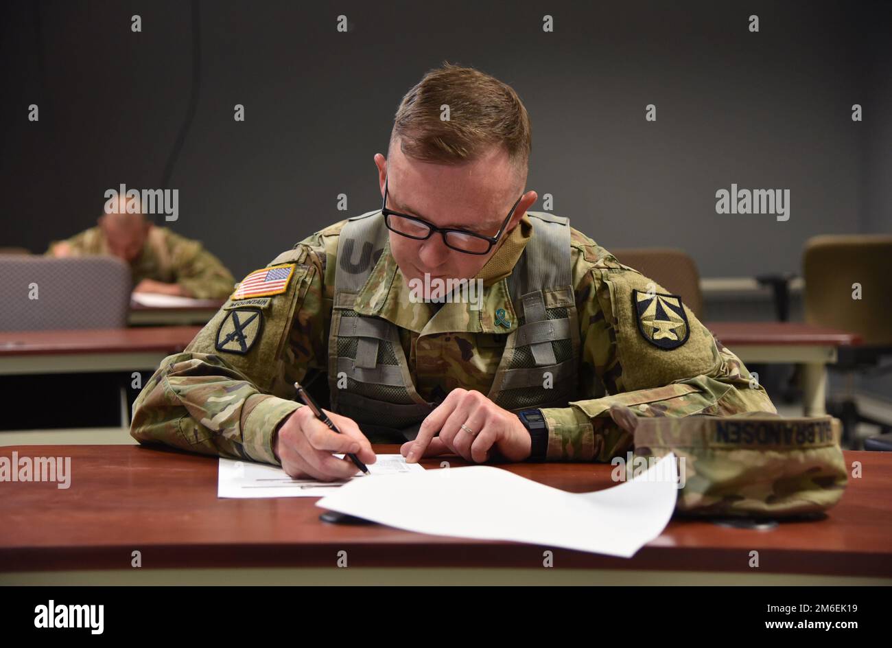 Sgt. 1st Class Robert Gulbrandsen works on the written weapons exam on ...