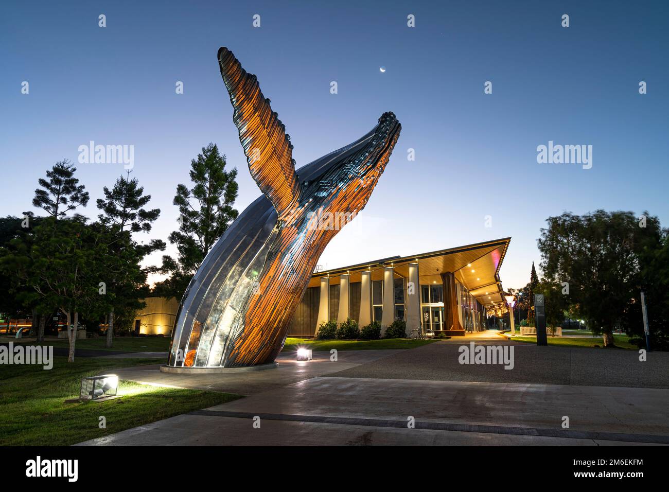 Sculpture of Nala the humpback whale floodlit in the evening outside ...