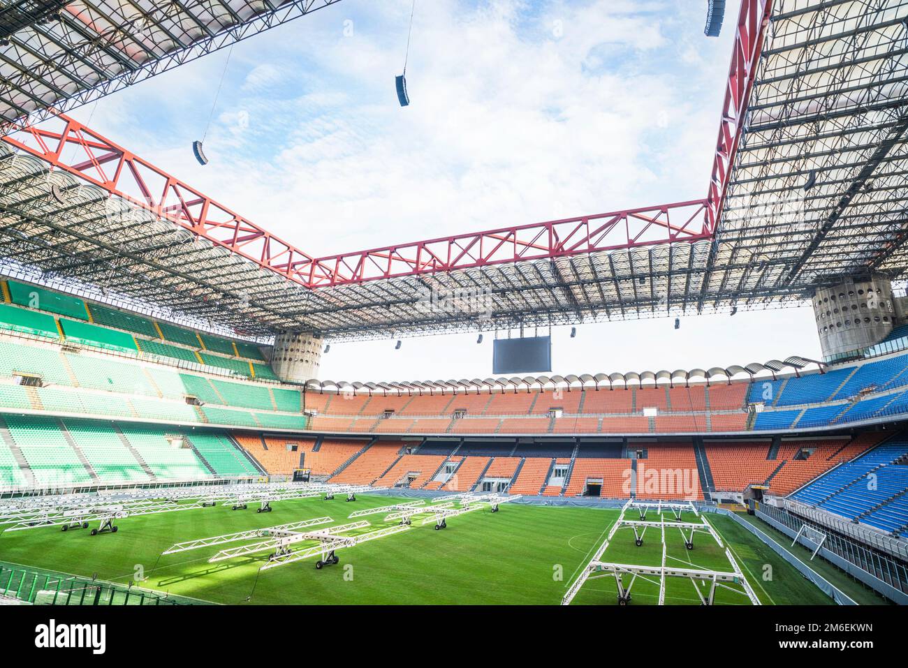 Football stadium with green field and lots of seats and a automatic ...
