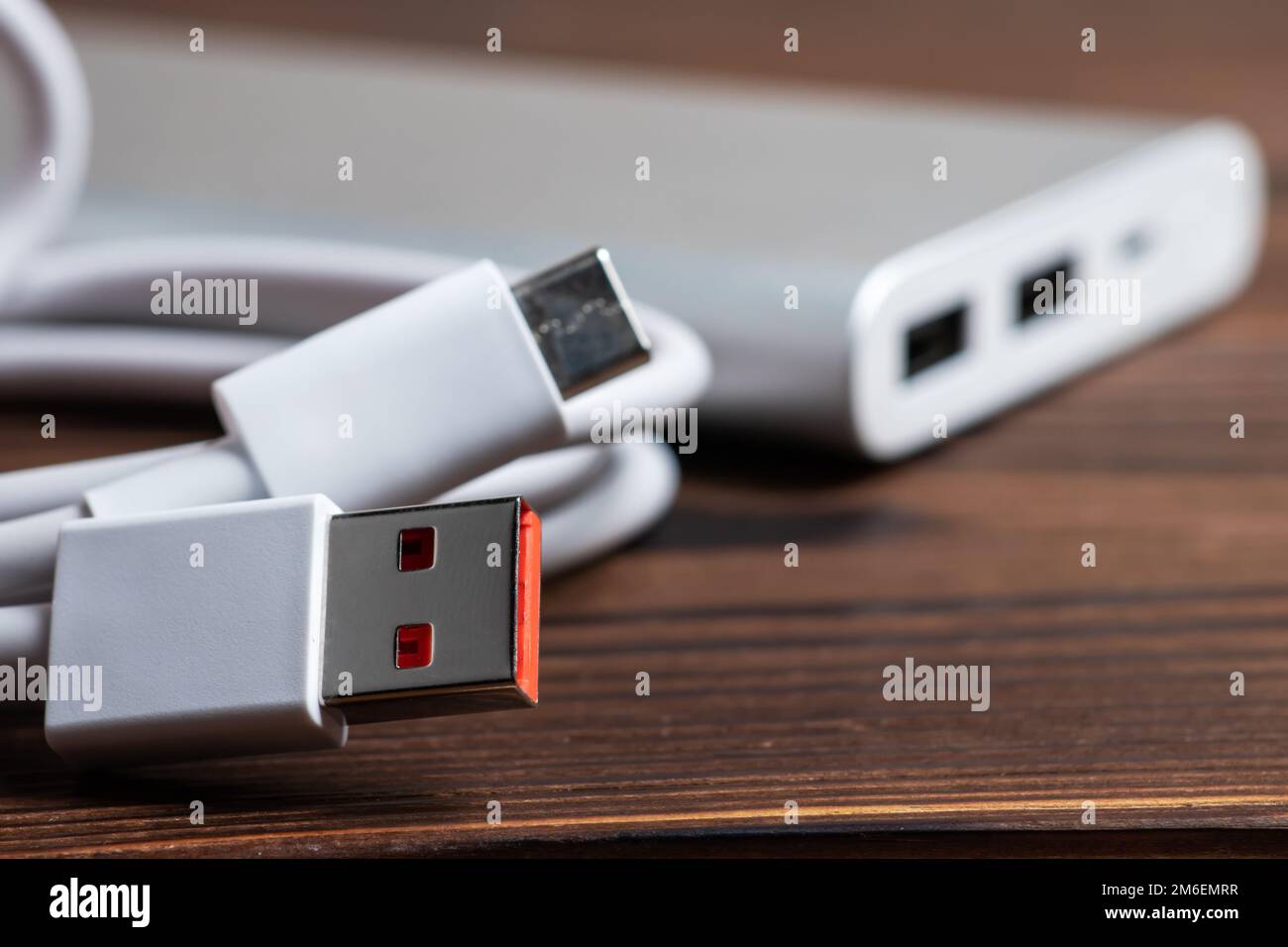 Portable aluminum power bank with USB cable on wooden background Stock ...