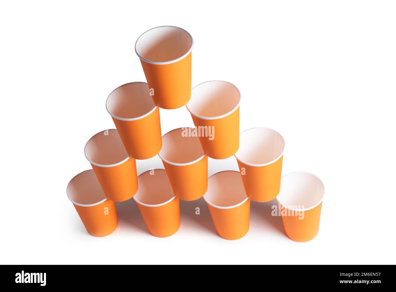Pyramid of orange disposable paper cups isolated on white background ...
