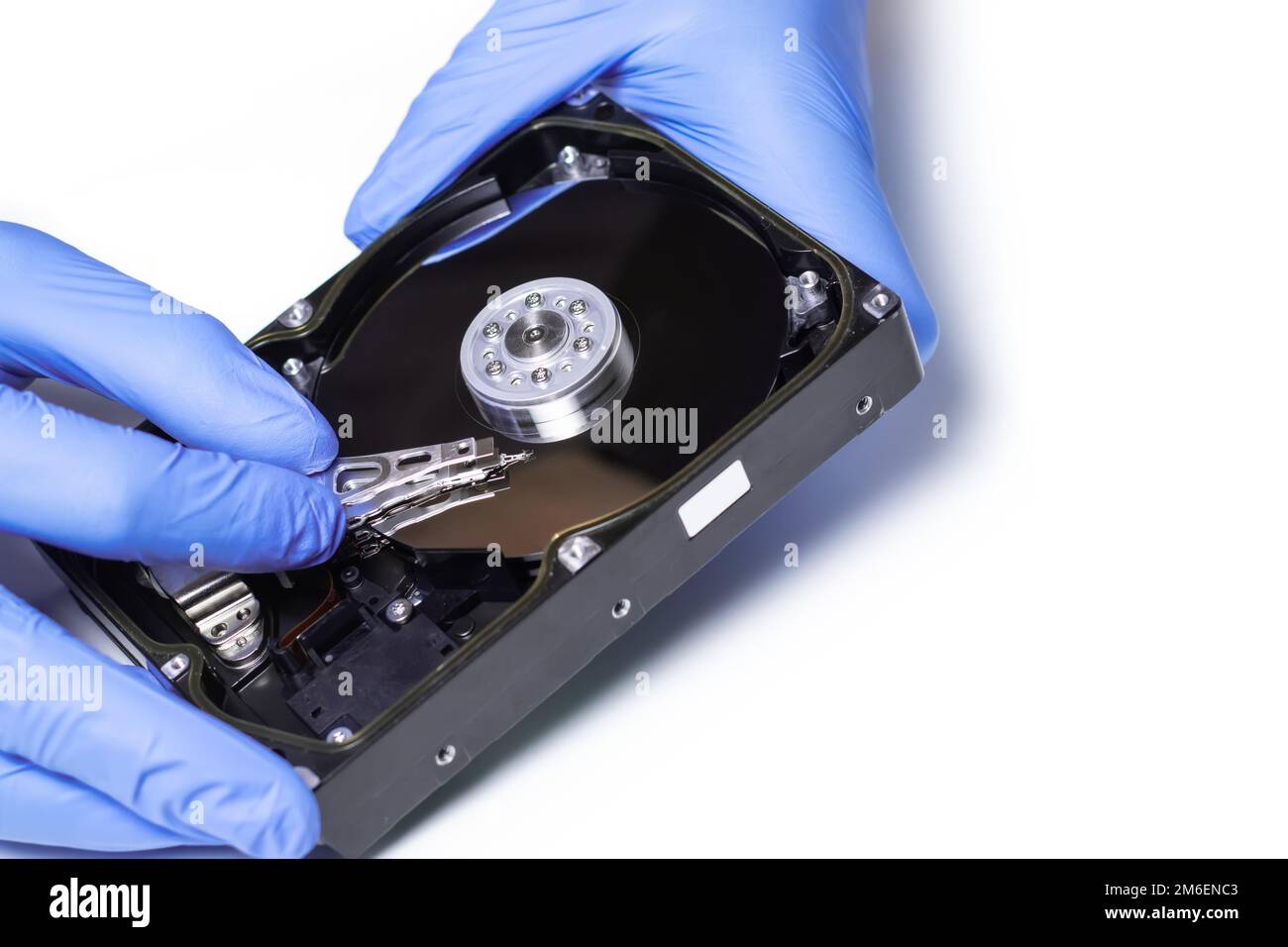 Repair Hard disk. Hands of master in gloves repair the computer hard drive. Data cleaning, HDD ...