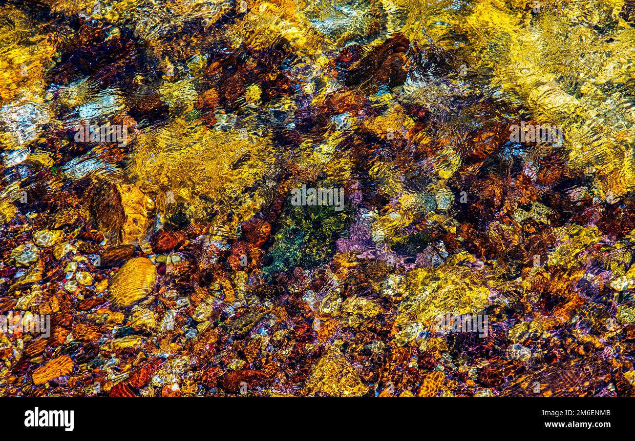 smooth clear water float on colored stone Stock Photo - Alamy