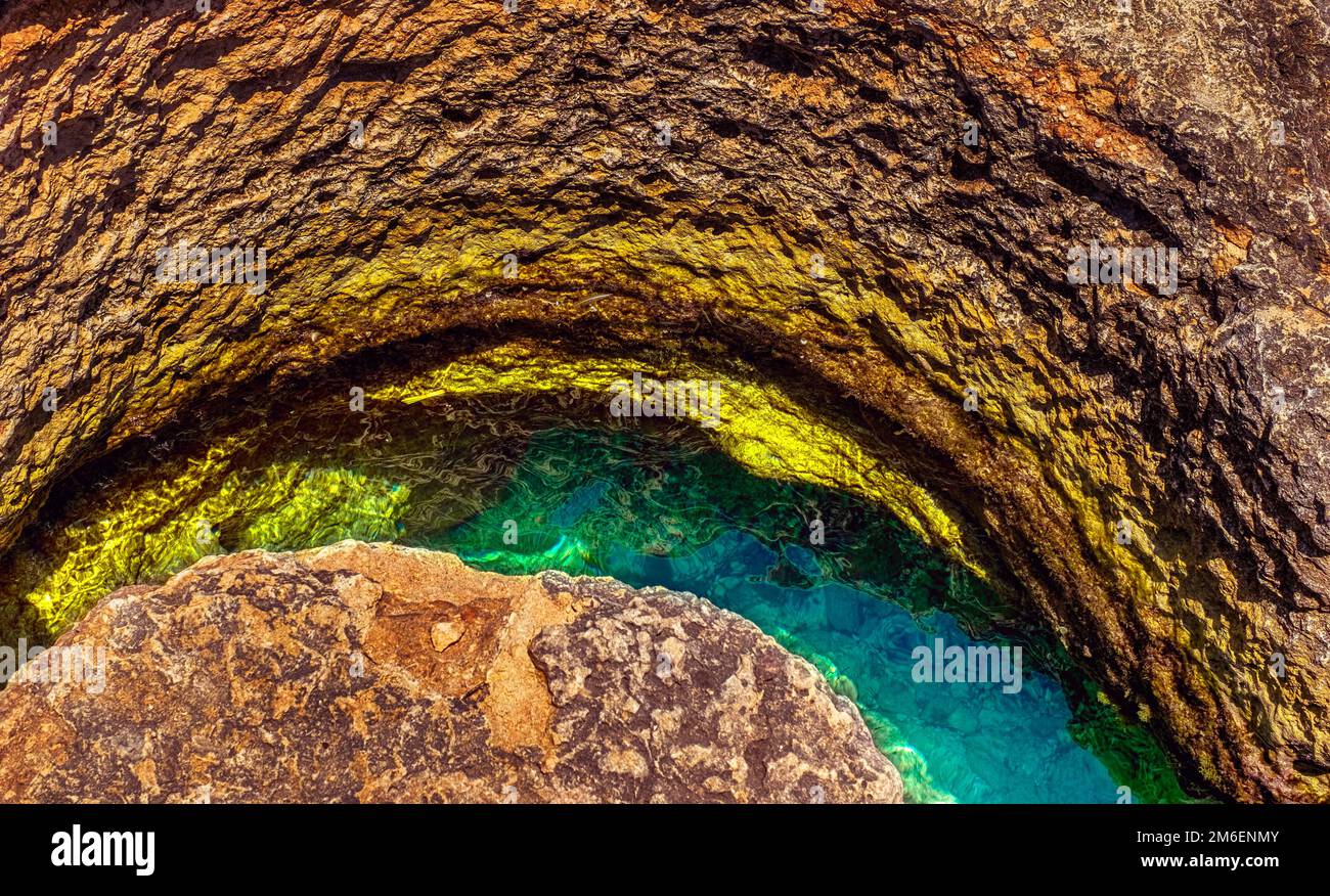 the blue water in the crack between the rocks Stock Photo - Alamy