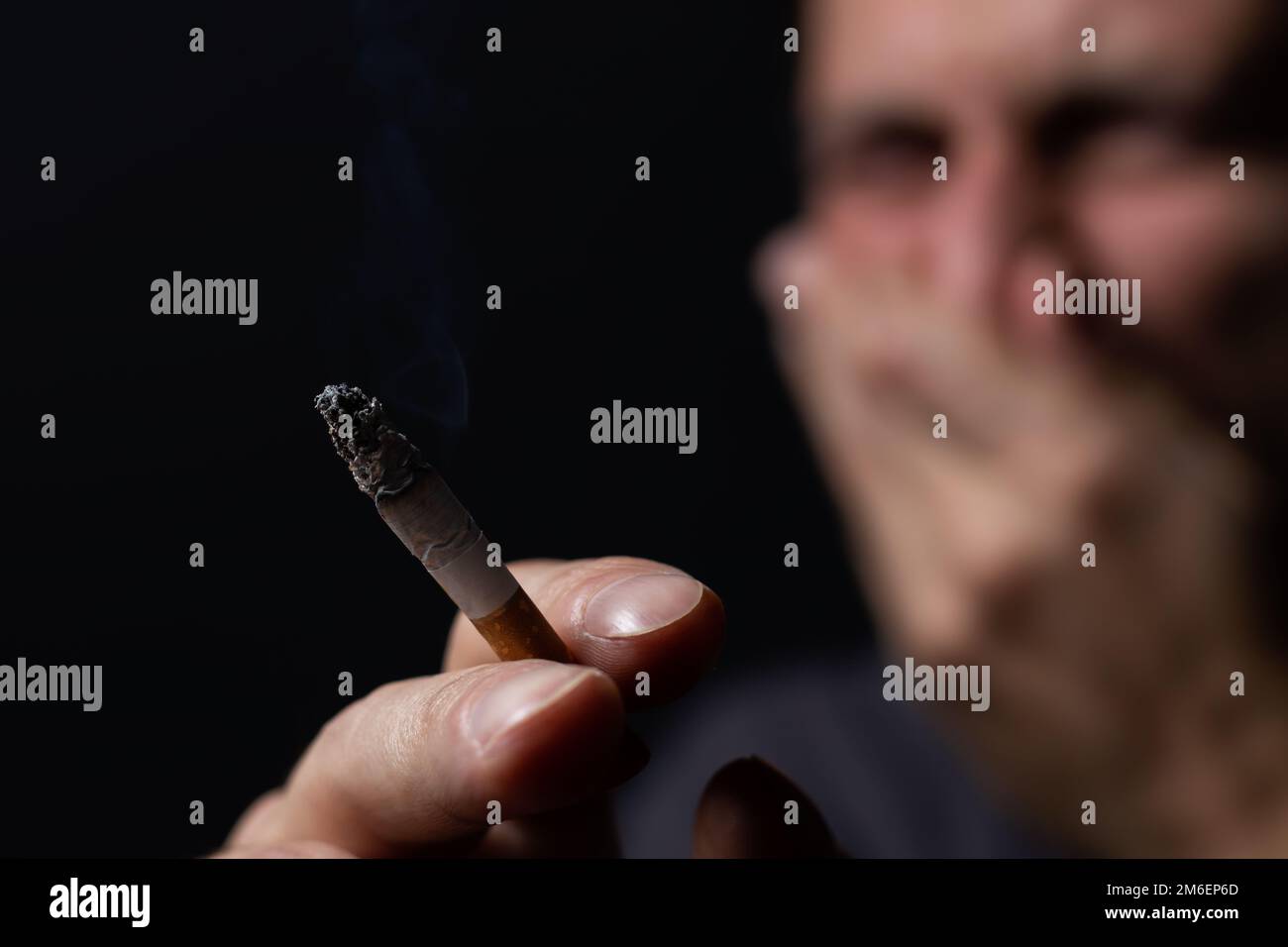 Passive smoking concept. Man is smoking cigarette and man is covering ...