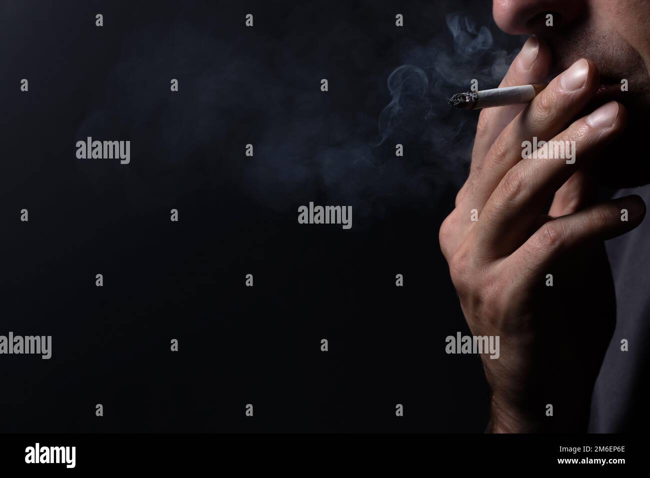 Smoking cigarette in the hand of young man close up Stock Photo - Alamy