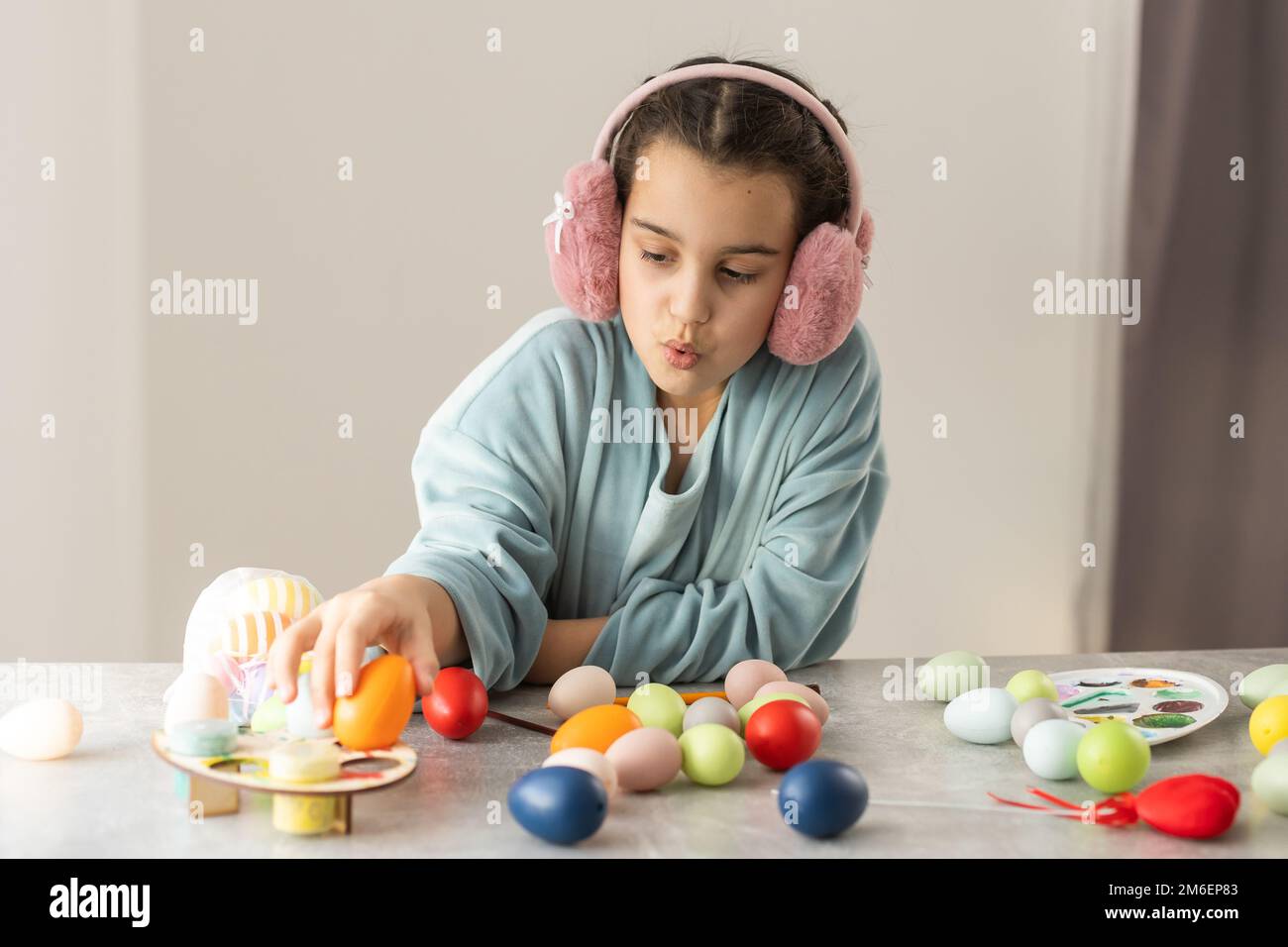Little girl with Easter eggs indoors Stock Photo - Alamy