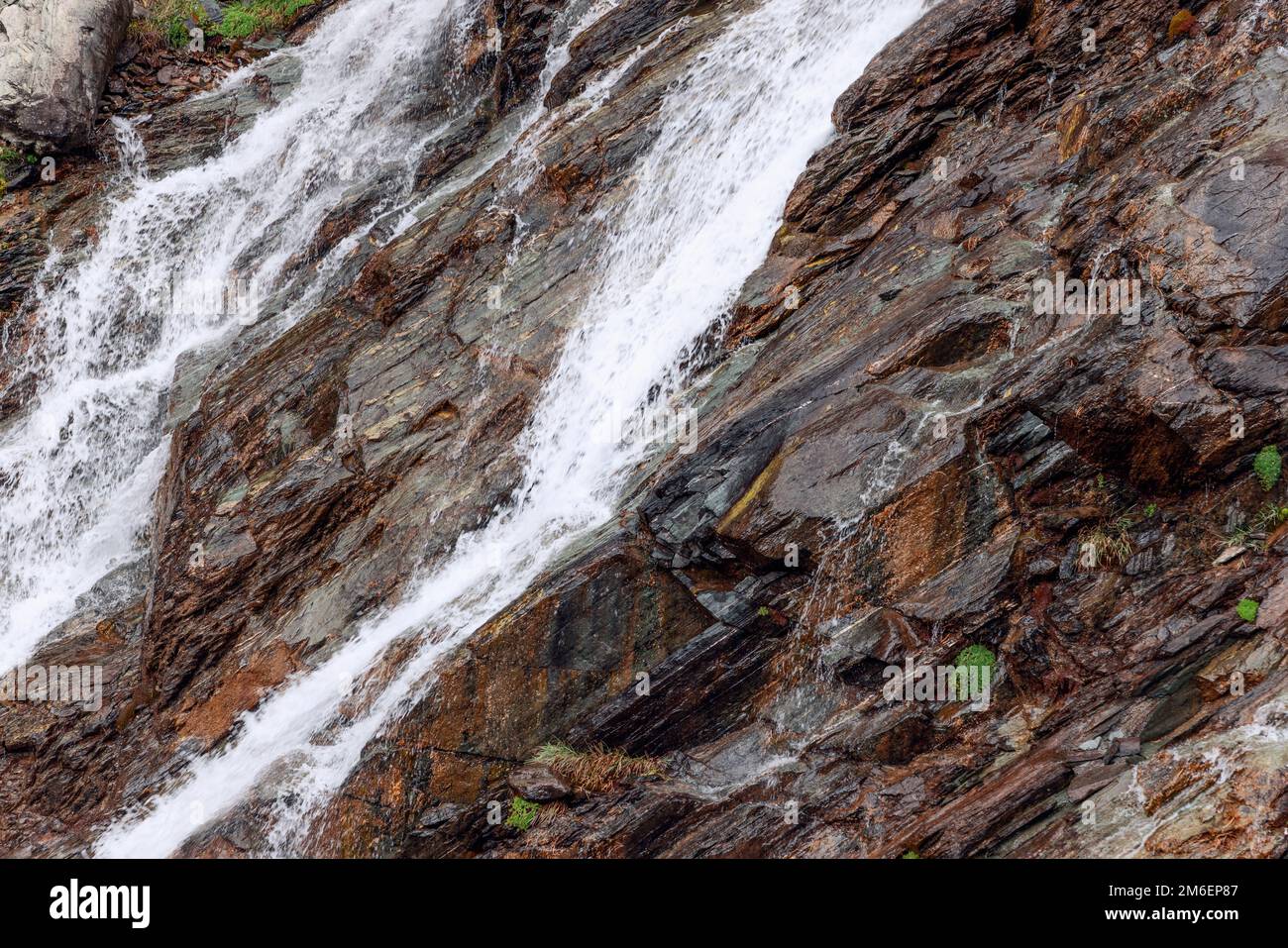 contrast shot of karst layers of granite rocks of various shades of ...