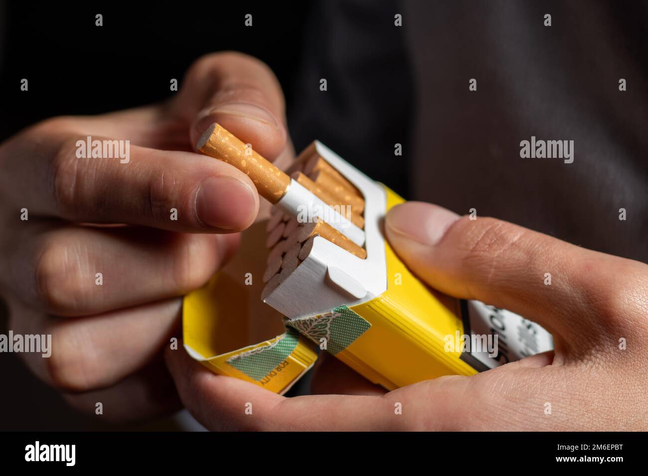 close up man hand holding peel it off cigarette pack prepare smoking a ...