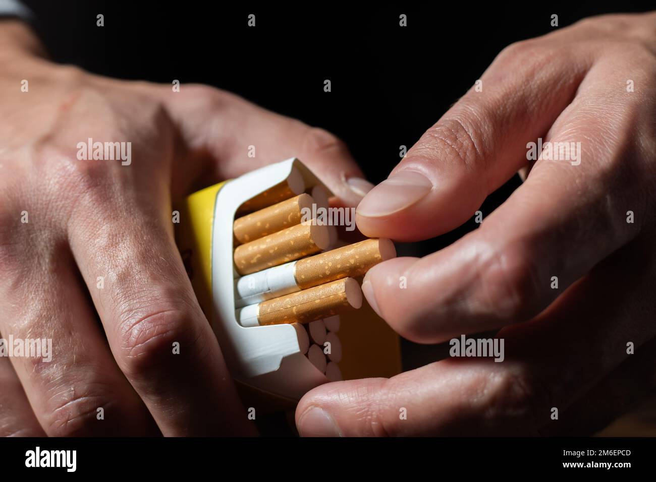 close up man hand holding peel it off cigarette pack prepare smoking a ...